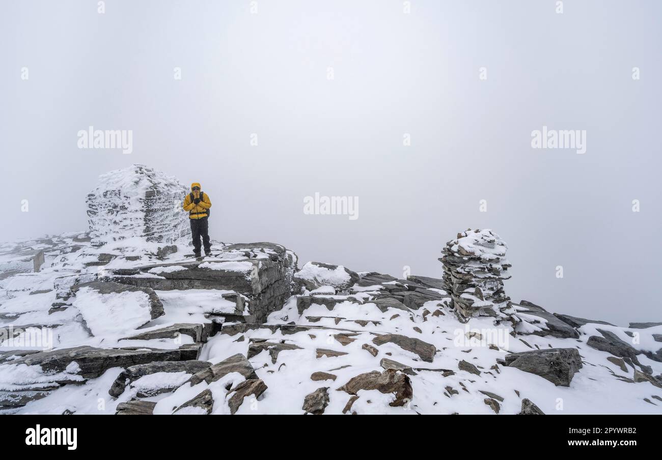 Climbers at the top of Snohetta Mountain, with snow, Dovrefjell ...