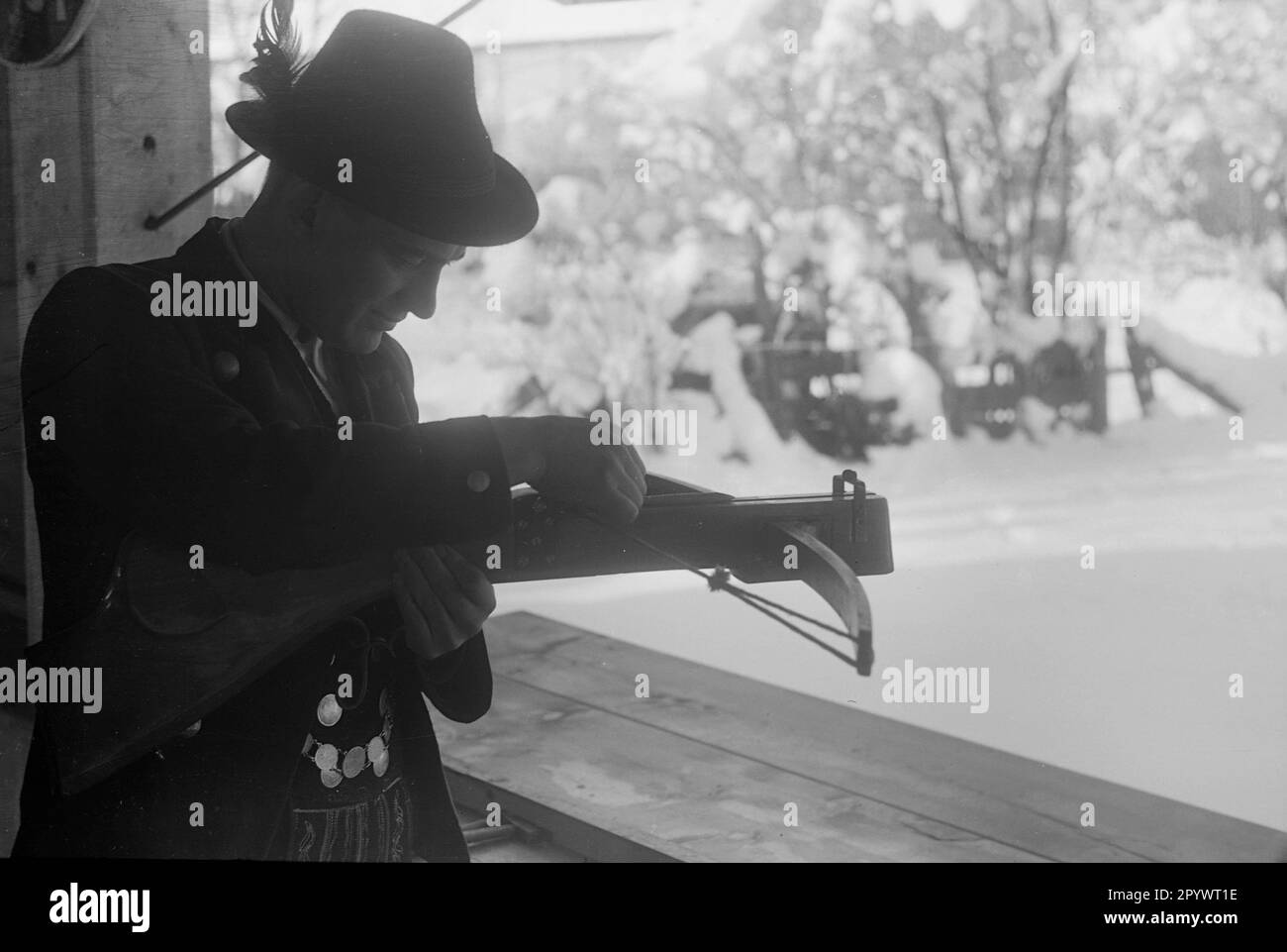 At a shooting range in St. Johann a marksman loads his crossbow ...