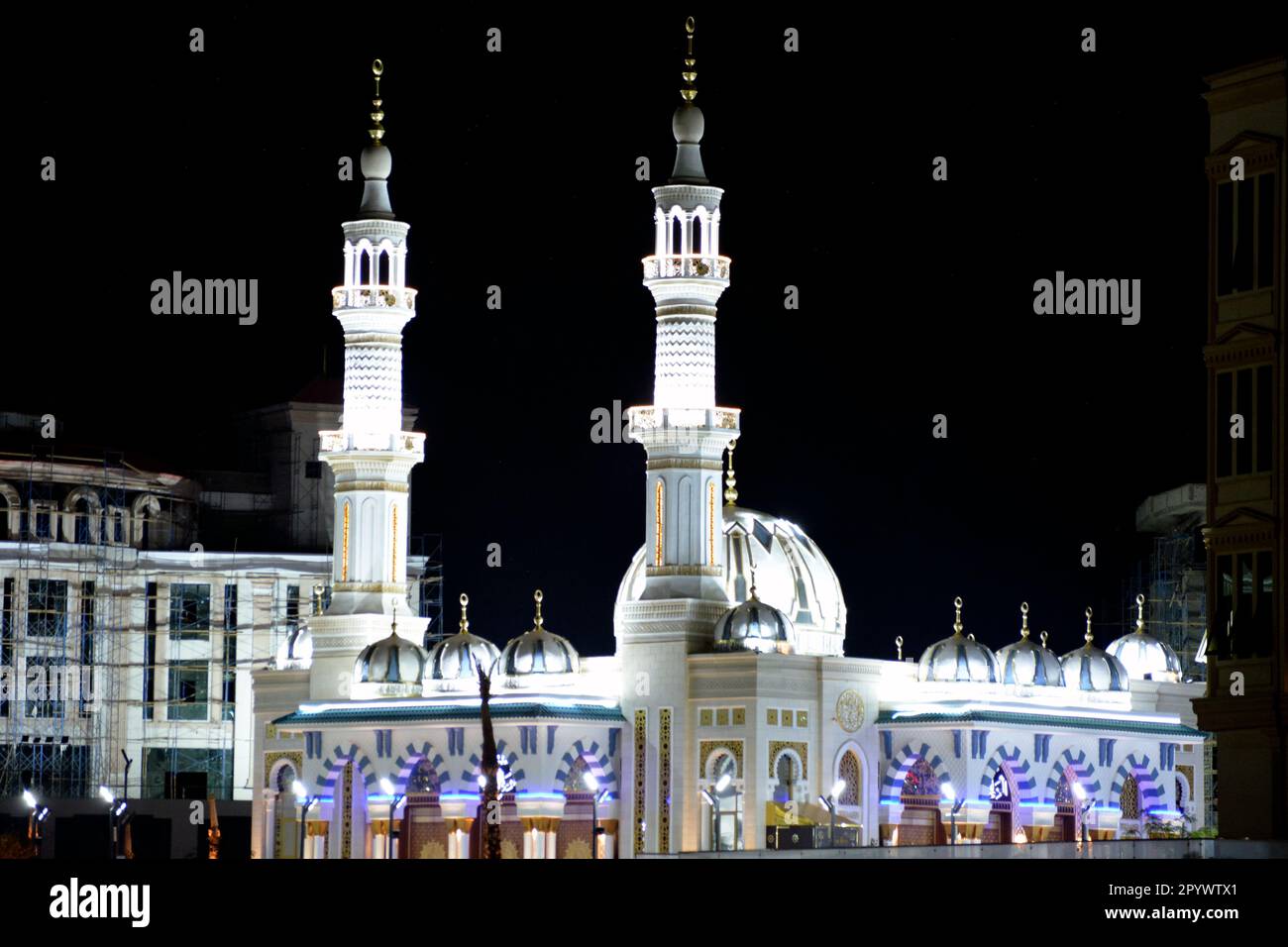 A beautiful white and blue mosque with multiple domes and minarets at ...