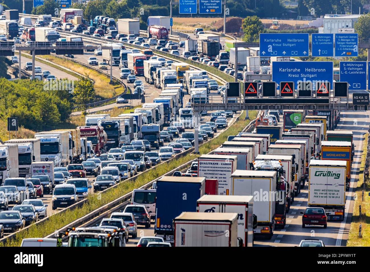Heavy traffic with congestion, trucks and cars on the A8 motorway near ...