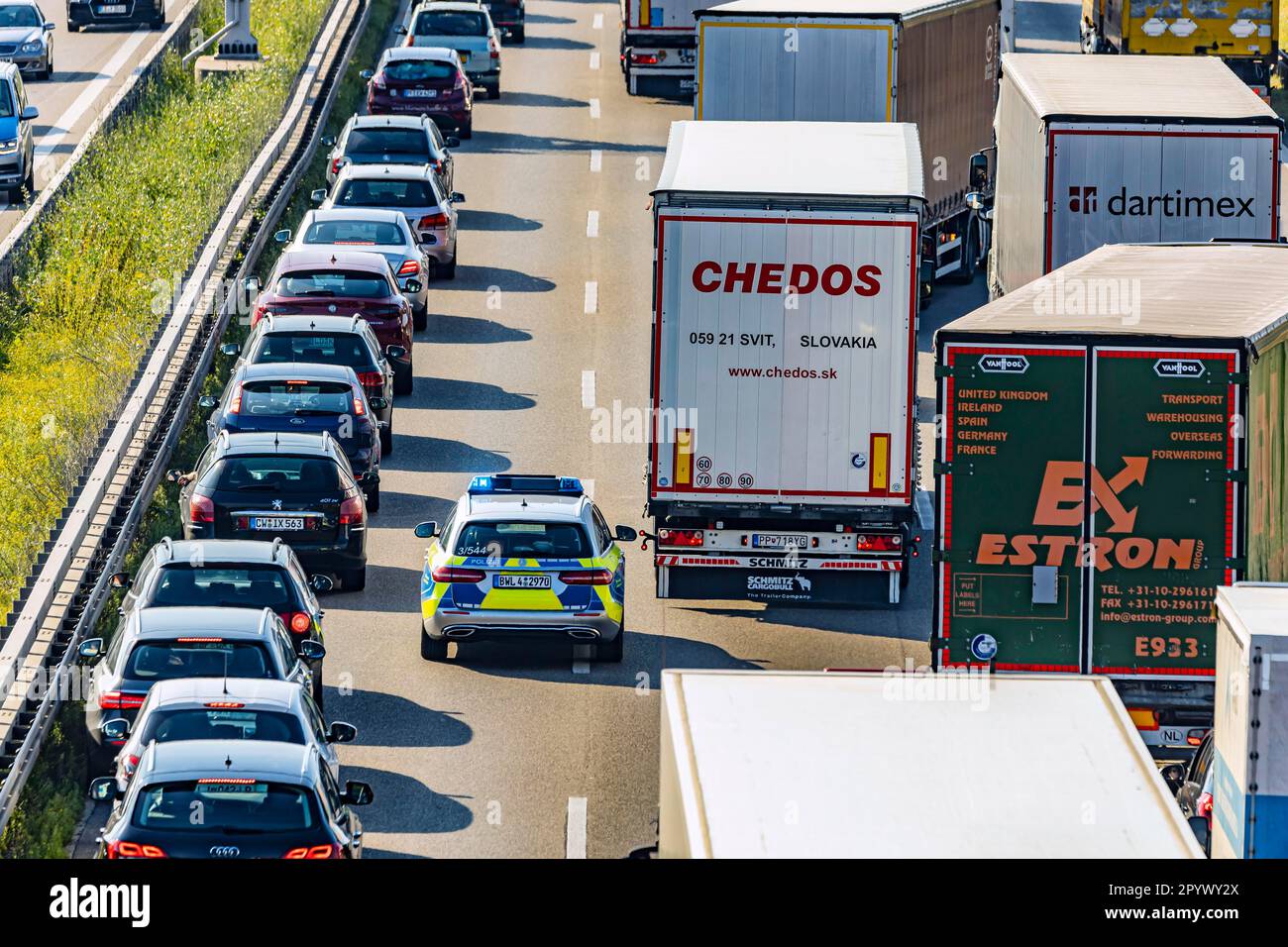 Police vehicle driving through an emergency lane, heavy traffic with ...