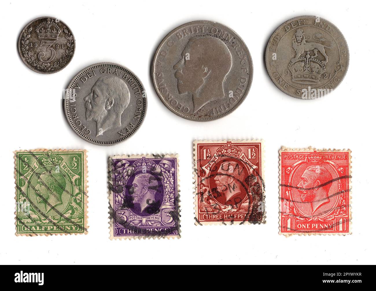 Vintage coins and stamps from the reign of King George V isolated on a ...