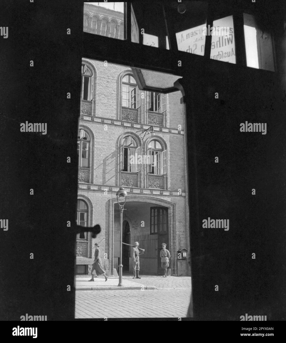 View of the guarded entrance of the Neustrelitz barracks through a ...