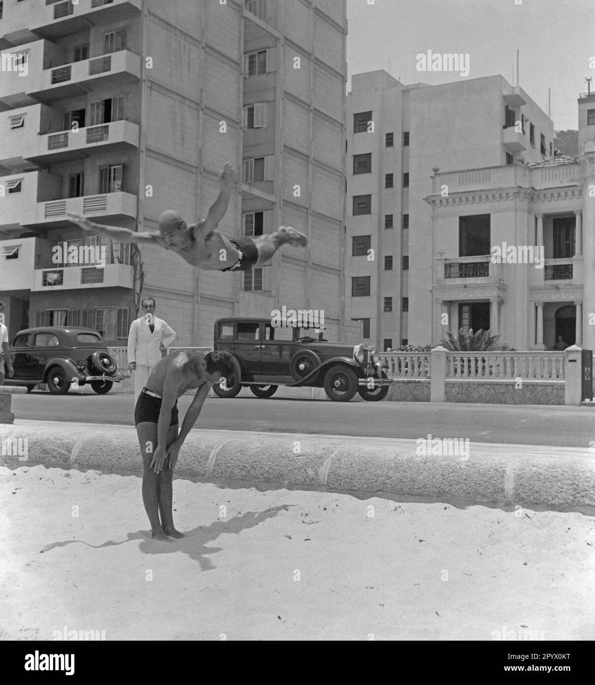 Two Brazilians doing an acrobatic performance on the beach Stock Photo ...