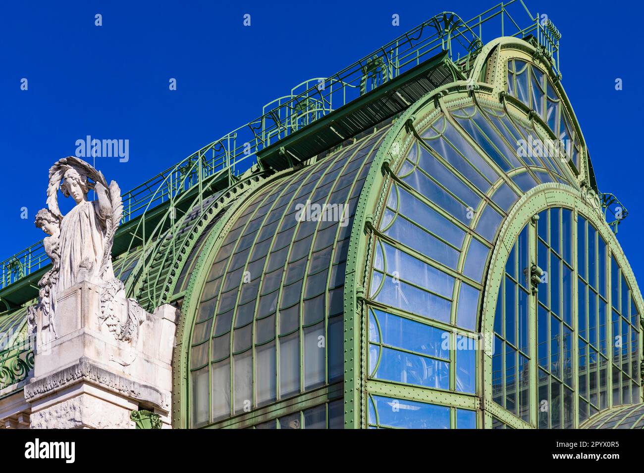Marble statue on the green roof of the Palm House at the Burggarten ...