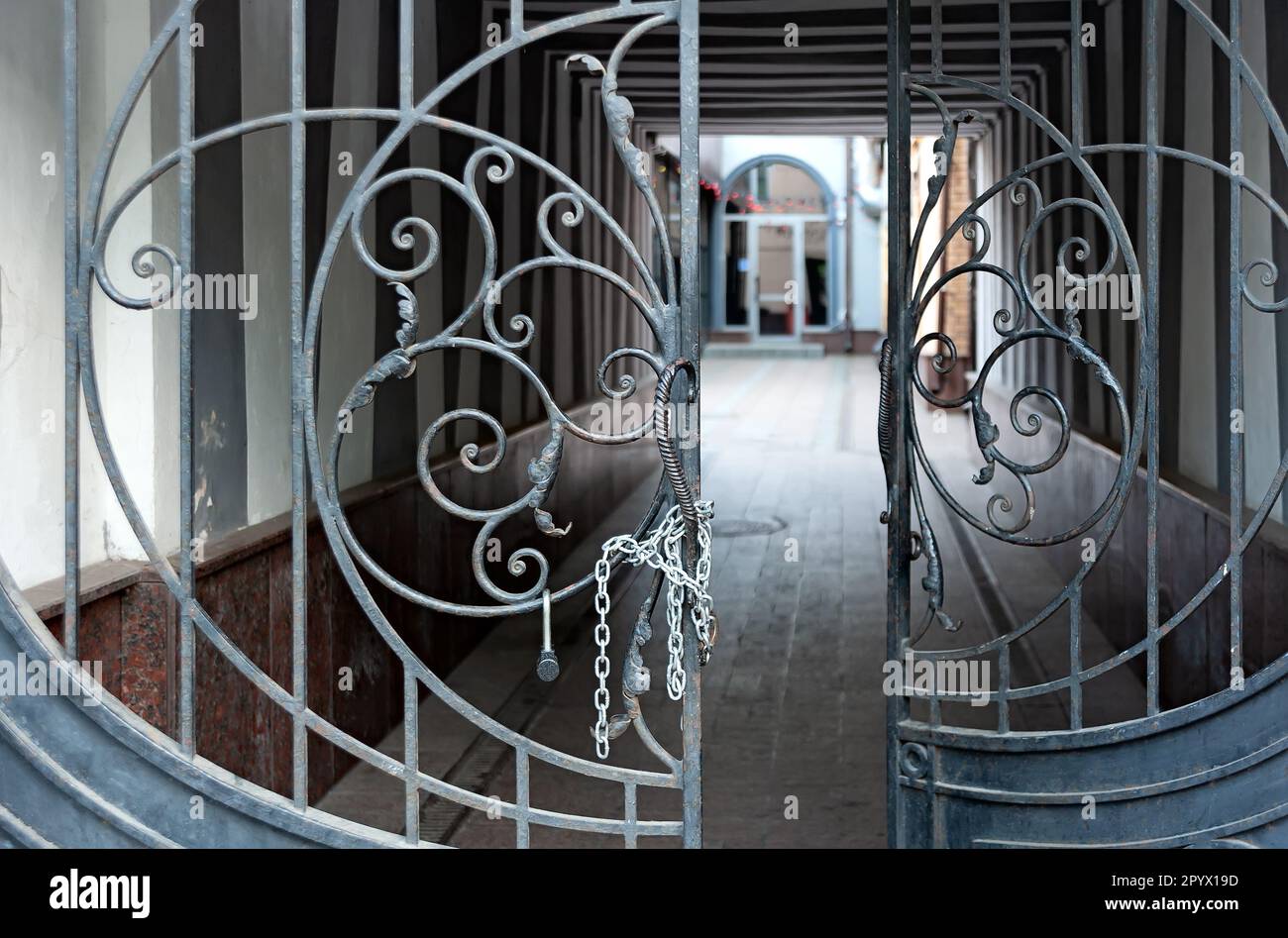 An opened wrought-iron gate with chained lock Stock Photo - Alamy
