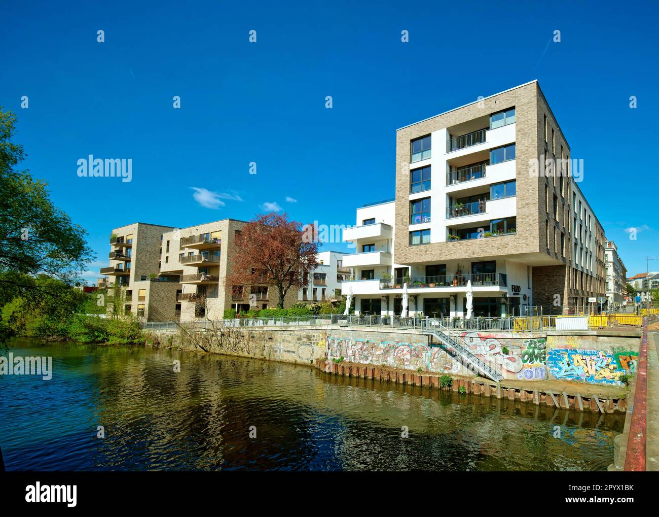 Modern residential buildings on the river Weisse Elster, Leipzig ...