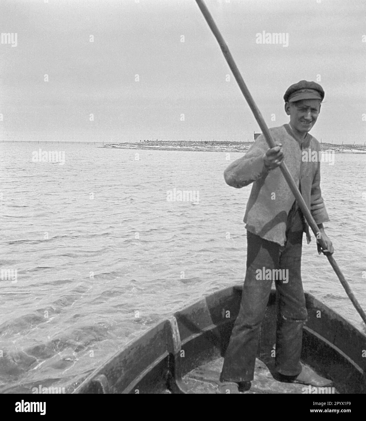 A boatman crossing to the bird sanctuary island Langenwerder. The island belonging to Poel is ...