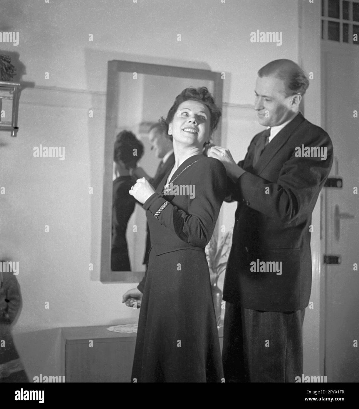 A Man Helps His Wife To Lock Her Necklace Scene From The Series We