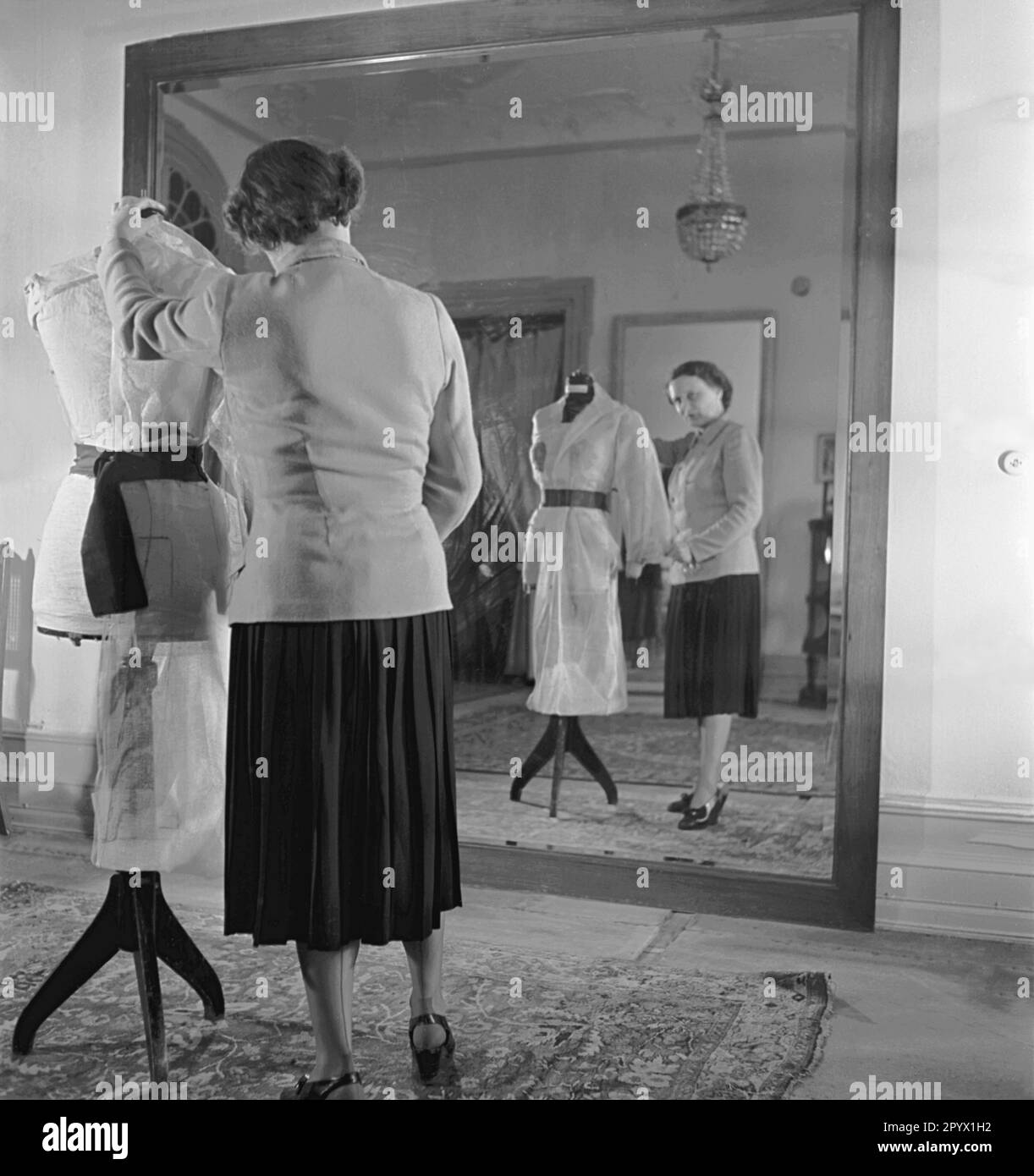 Woman working on a tailor's dummy Stock Photo - Alamy