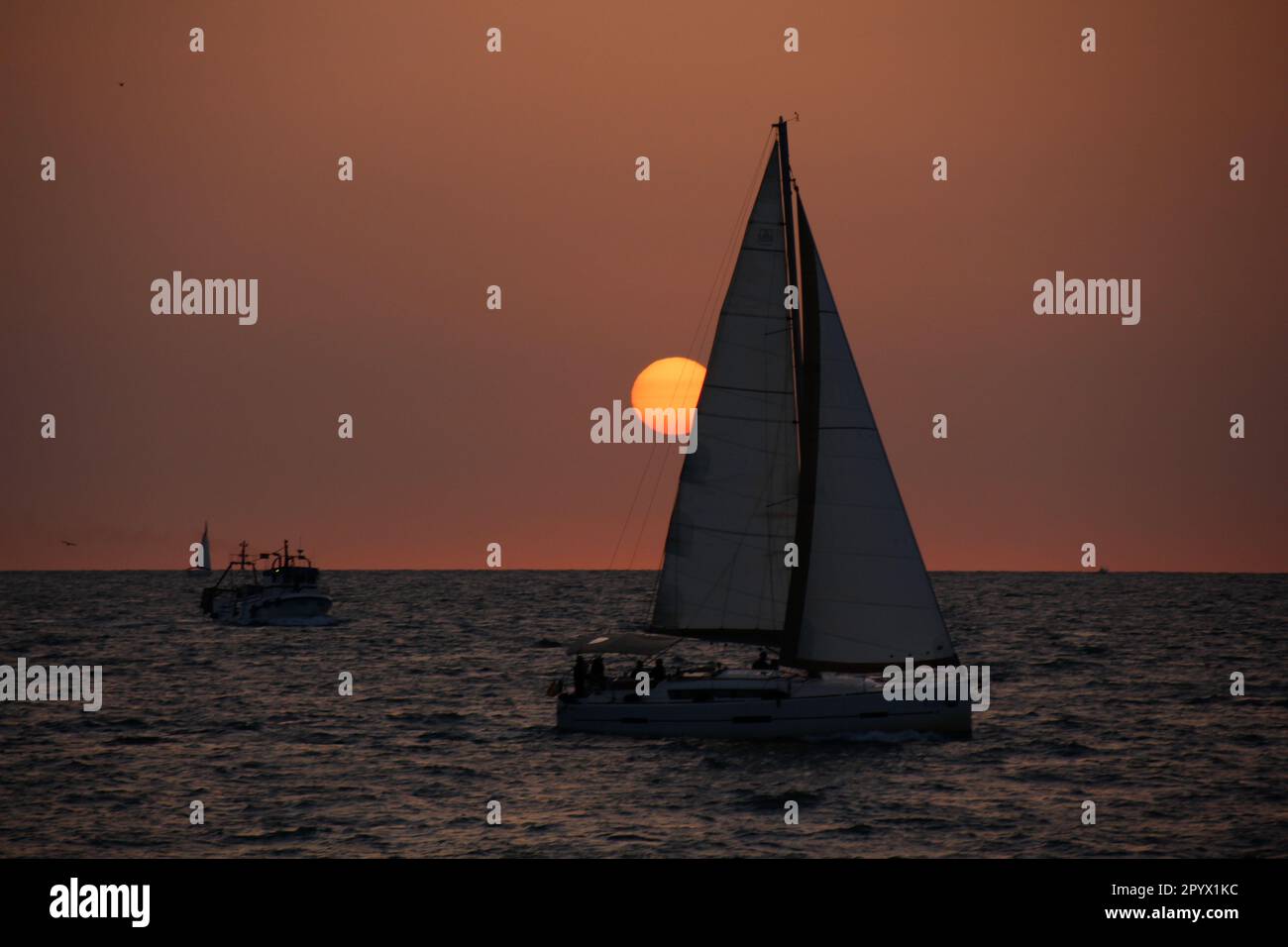 Two boats sailing in a tranquil body of water under the beautiful ...