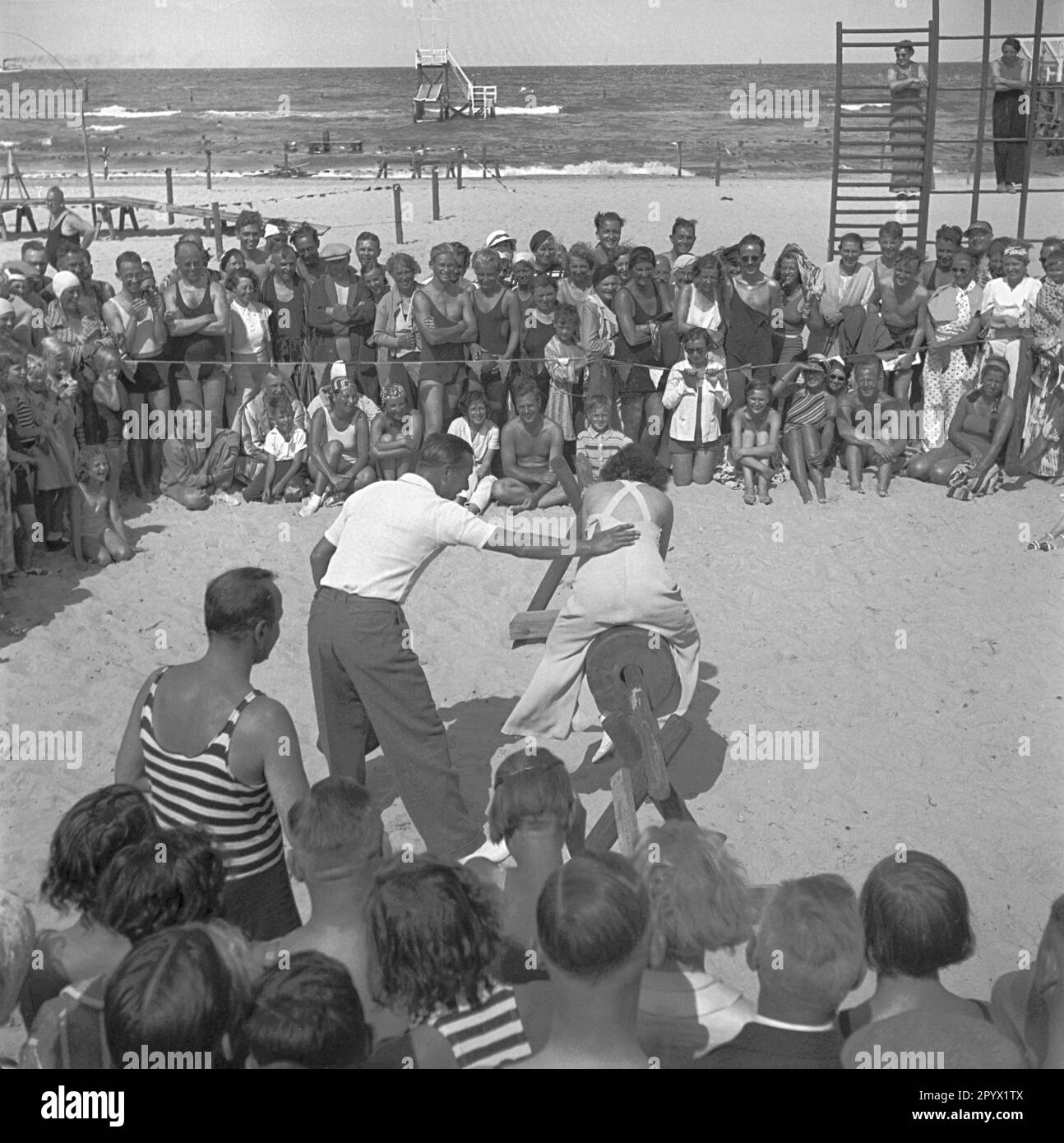 People at a competition on a beach party in Warnemuende. In the middle ...