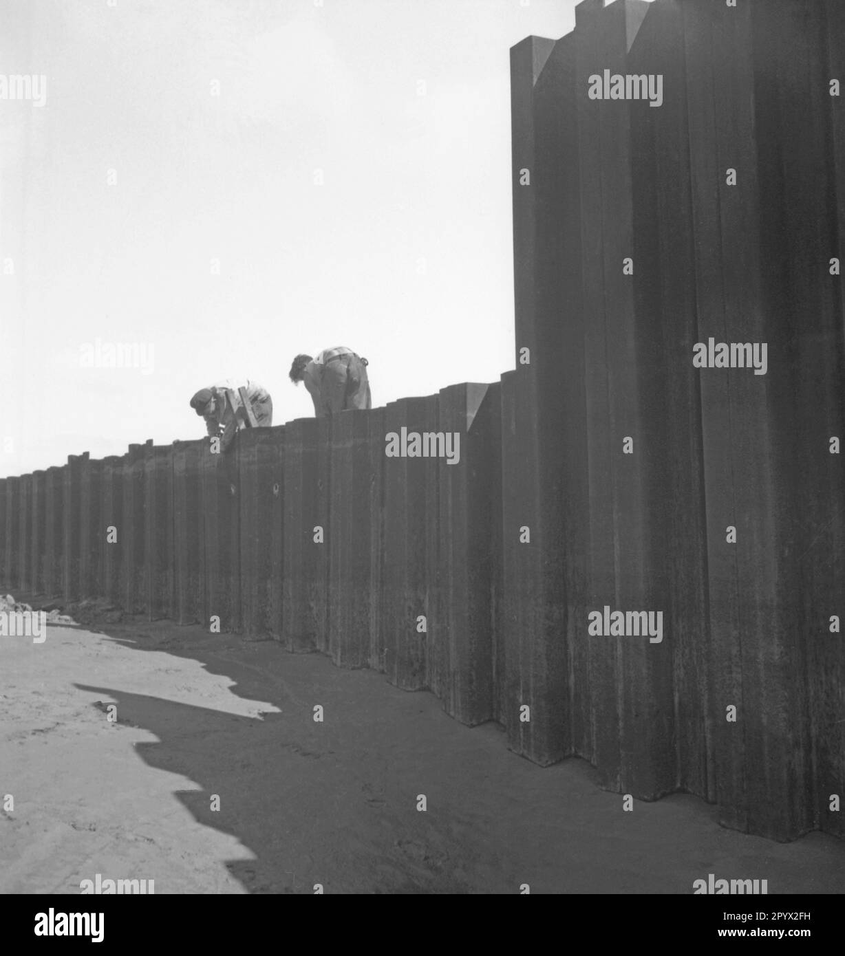 Workers erecting a dike wall. Undated photo, probably taken in 1934 ...