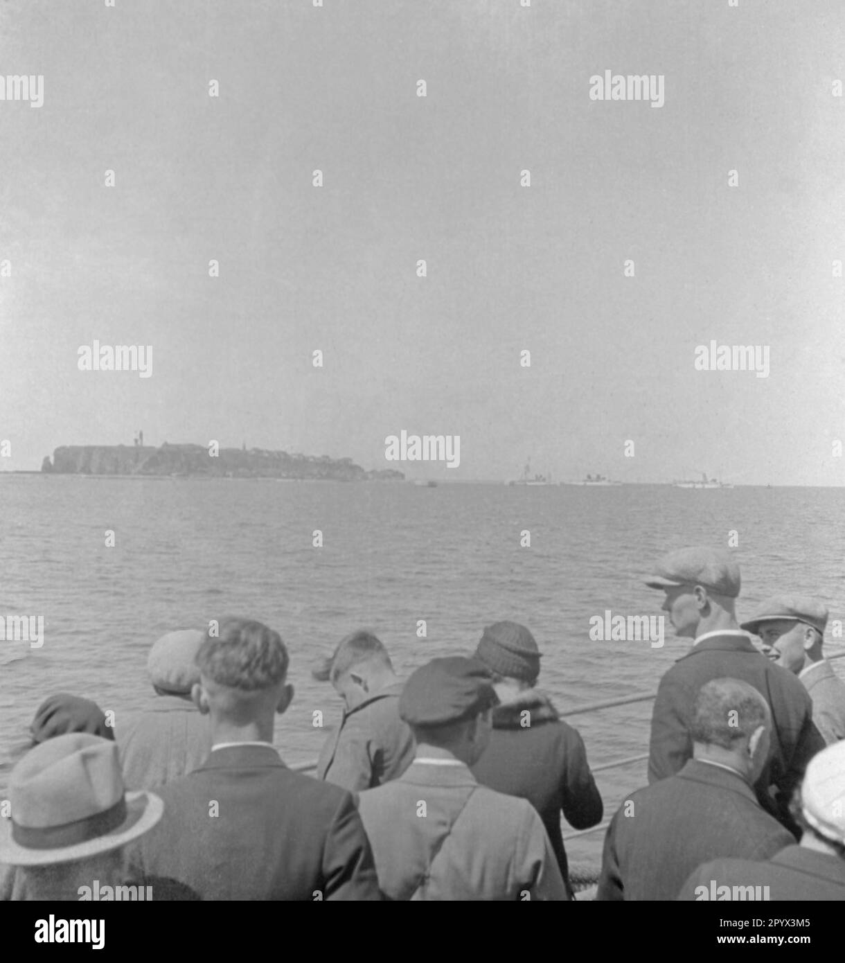 Trippers look at the North Sea island of Heligoland (in the background ...