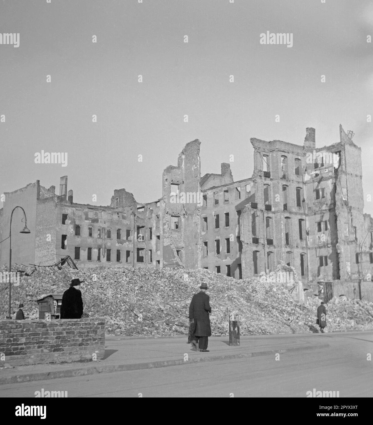 Undated photo of pedestrians in front of house frameworks in Berlin ...