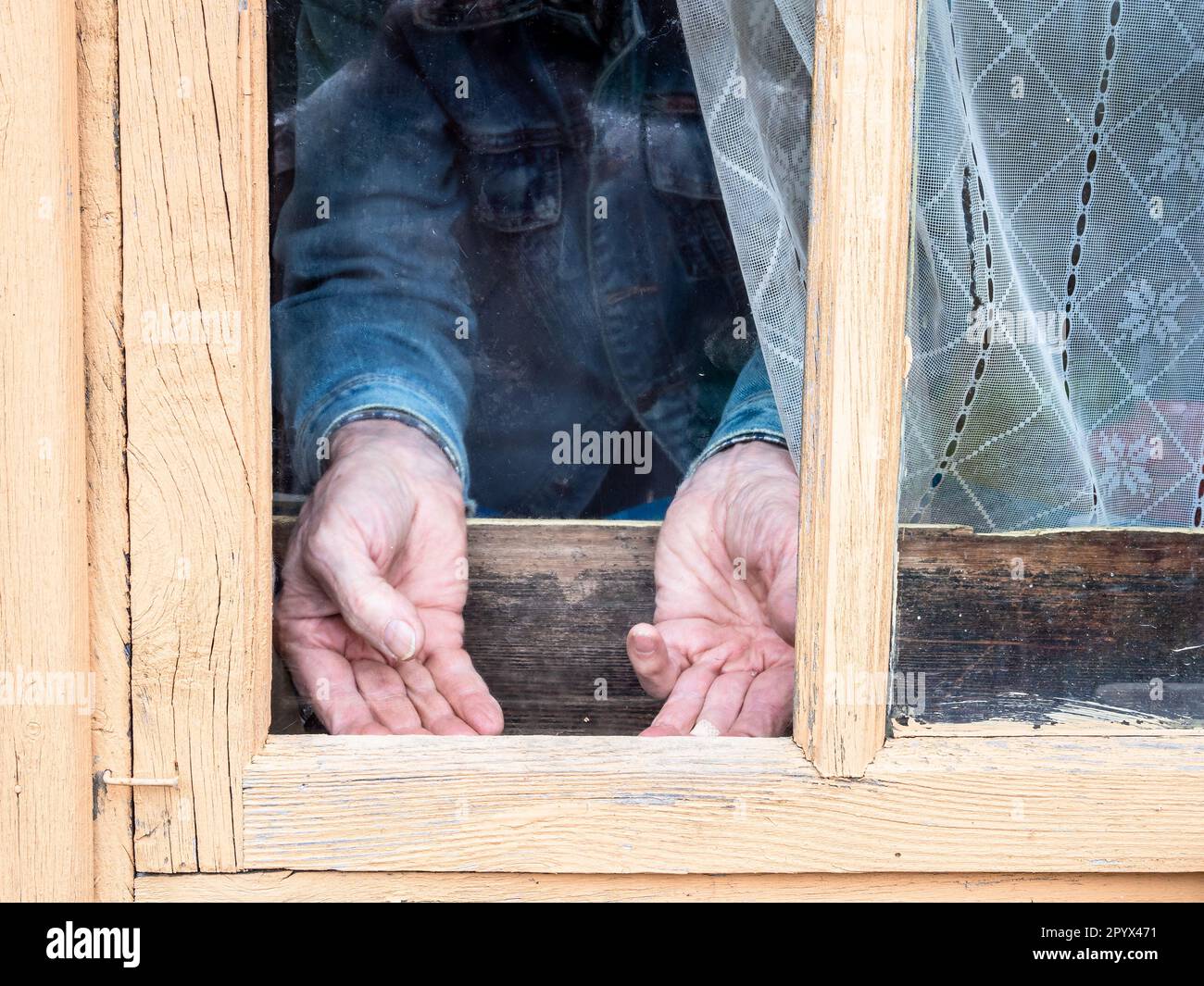 repair of wooden window frame and installation of window pane in rural ...