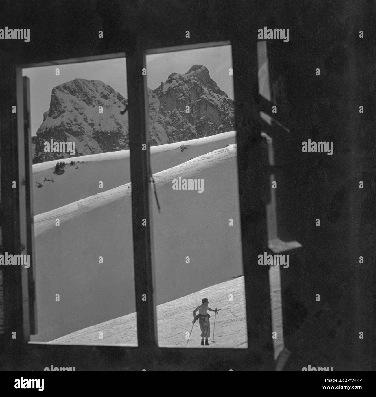 "View from a window onto a skier on a high alpine pasture near a ...