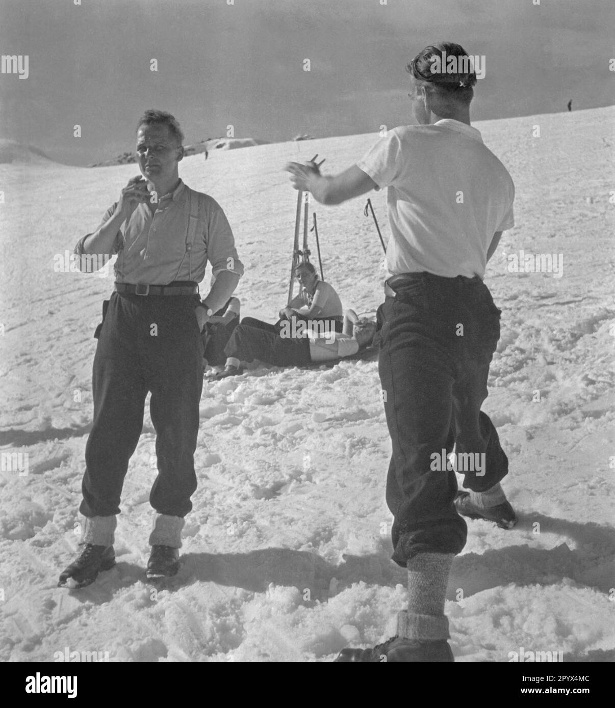 "Two men talk during a break. View on a high alpine pasture at a ...