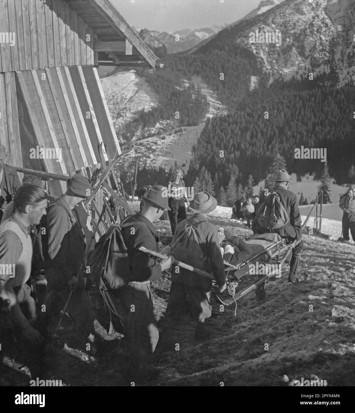 "Paramedics transport an injured person on a stretcher on a high alpine ...