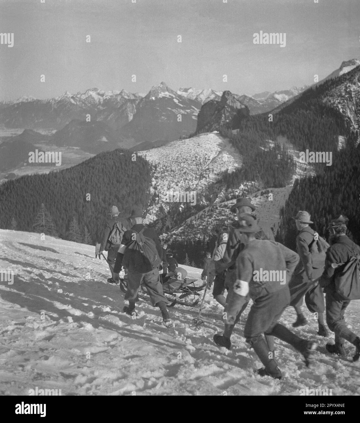 "Paramedics transport an injured person on a stretcher. High alpine ...