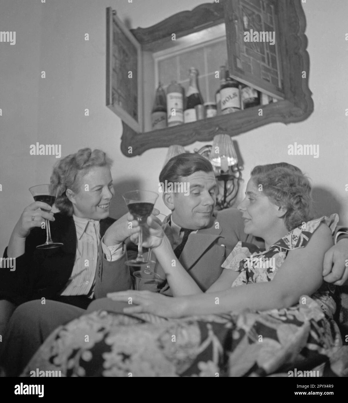 Woman drinking from champagne bottle Black and White Stock Photos ...