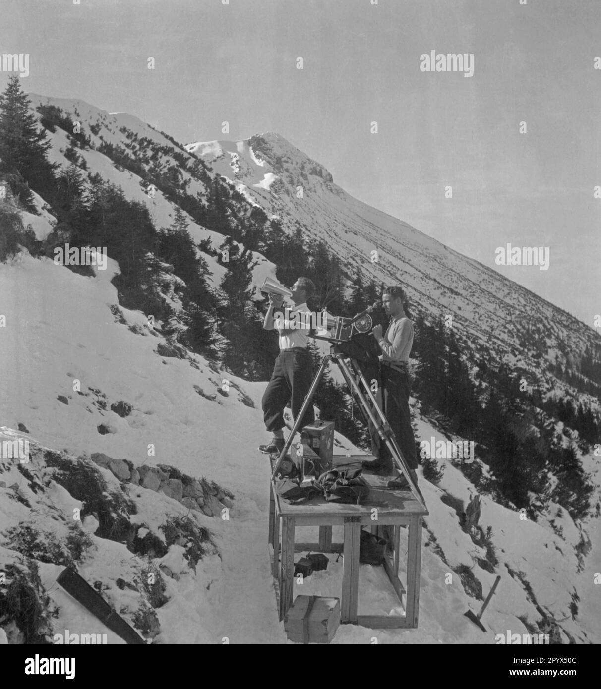 "Two cameramen film with a camera on a pedestal on a high alpine ...