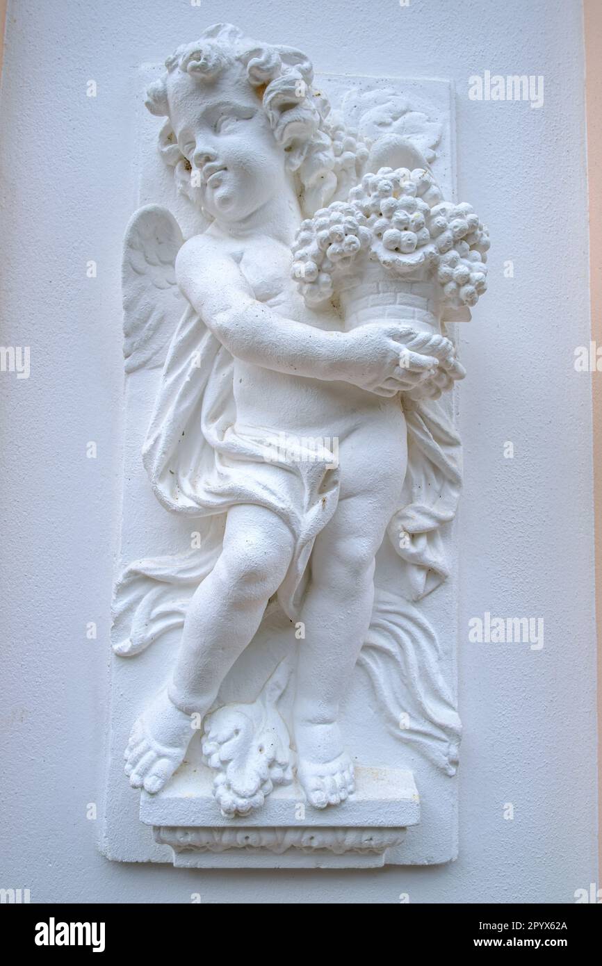 Childlike angel figure on the wall of a noble architecture in the villa ...