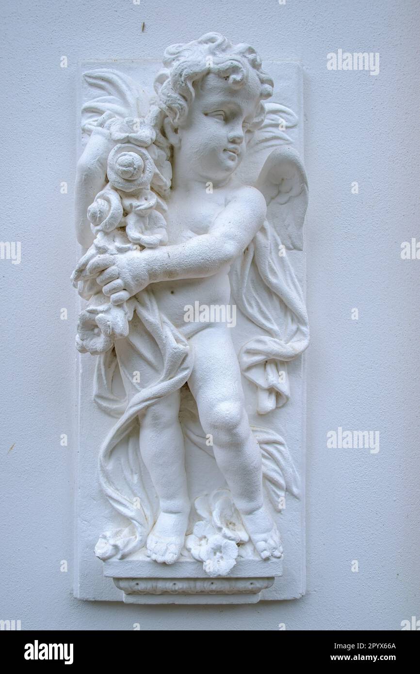 Childlike angel figure on the wall of a noble architecture in the villa ...