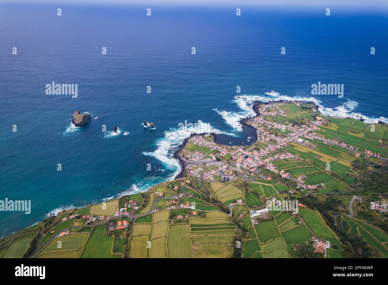 Aerial view of the coastline on Sao Miguel Island, with town buildings ...