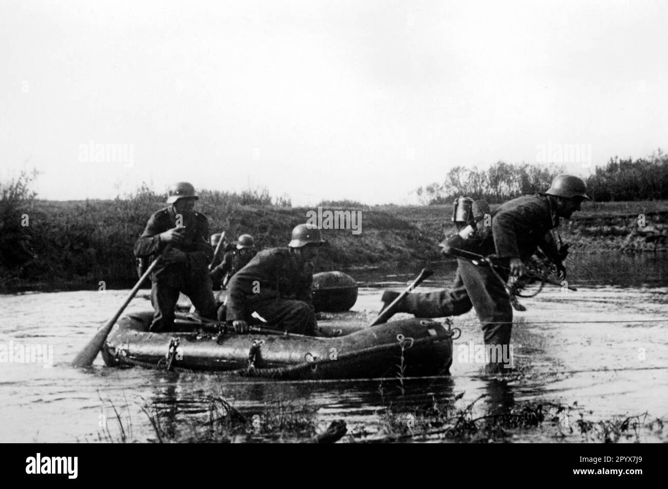 German infantrymen crossing a river in an inflatable boat. Photo: Paul ...
