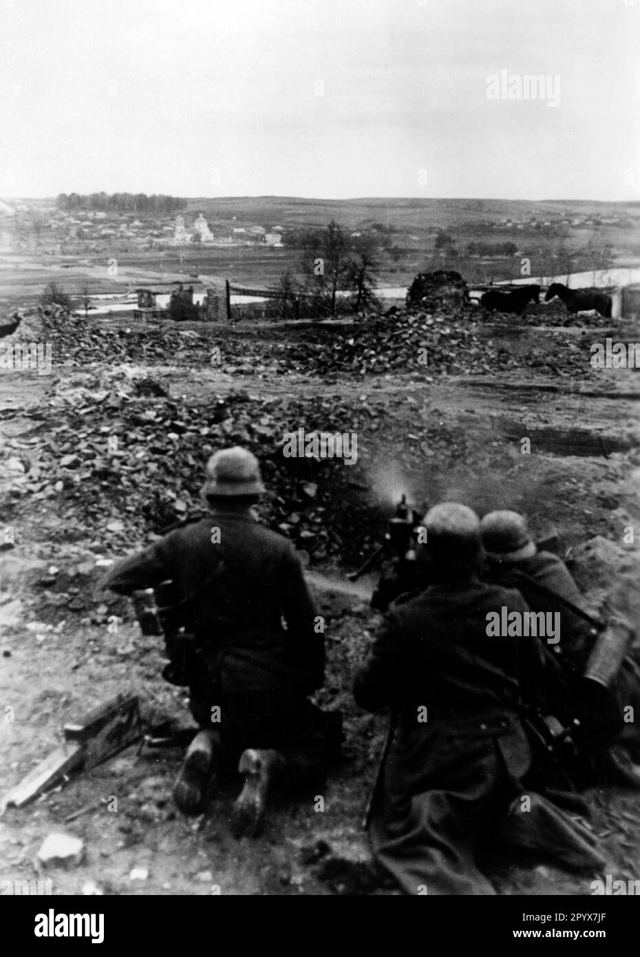German soldiers firing a heavy machine gun at Soviet positions. Photo ...