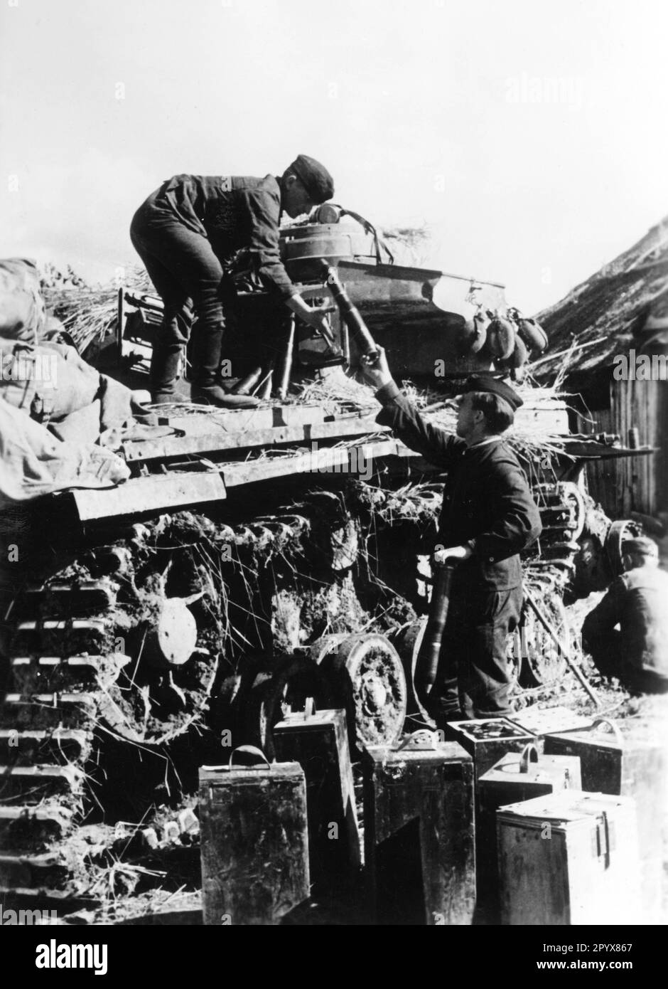 Tank soldiers ammunition their Panzer III near Rzhev in the central ...