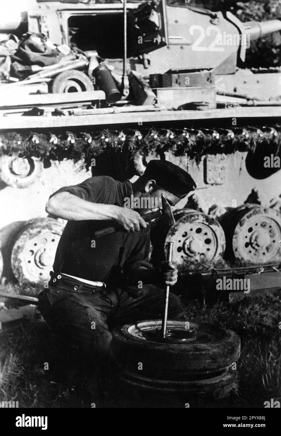 A soldier working on a roller of a Panzer III during the fighting in ...