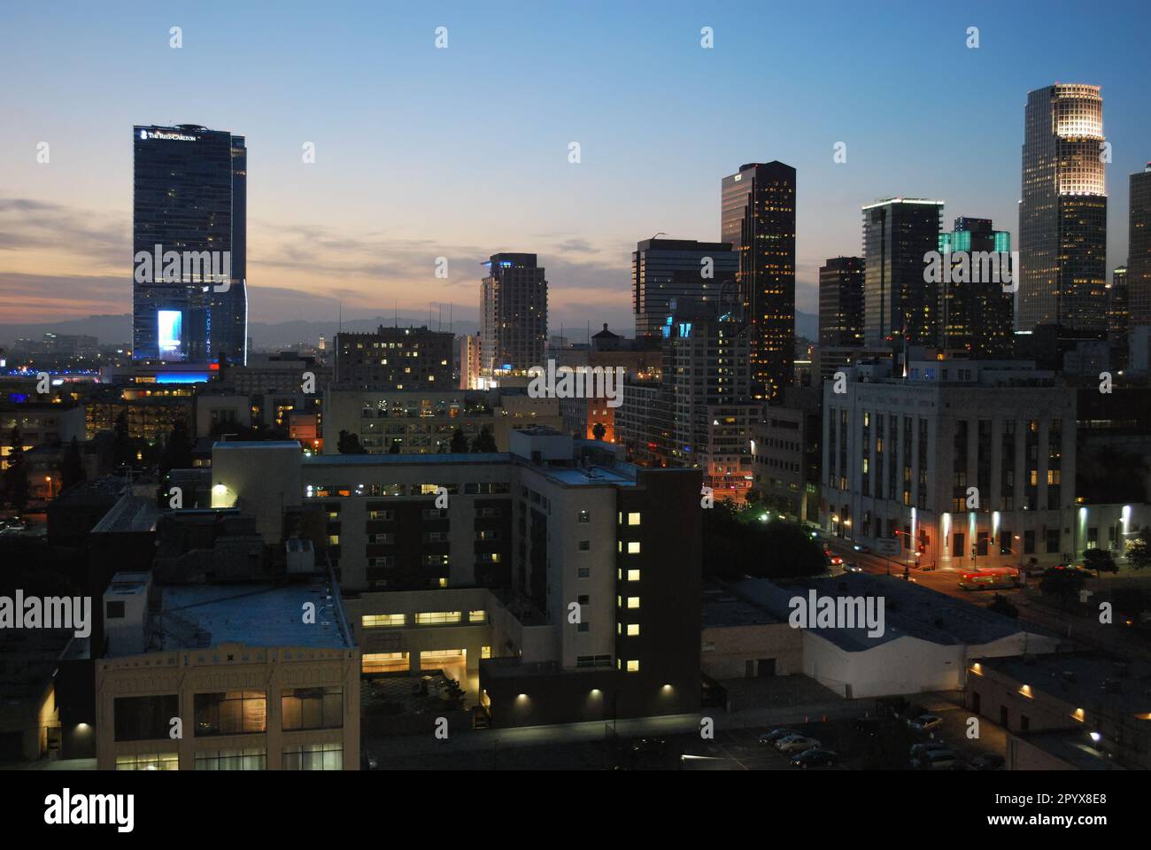 A breathtaking aerial view of a vibrant city illuminated by nightfall ...