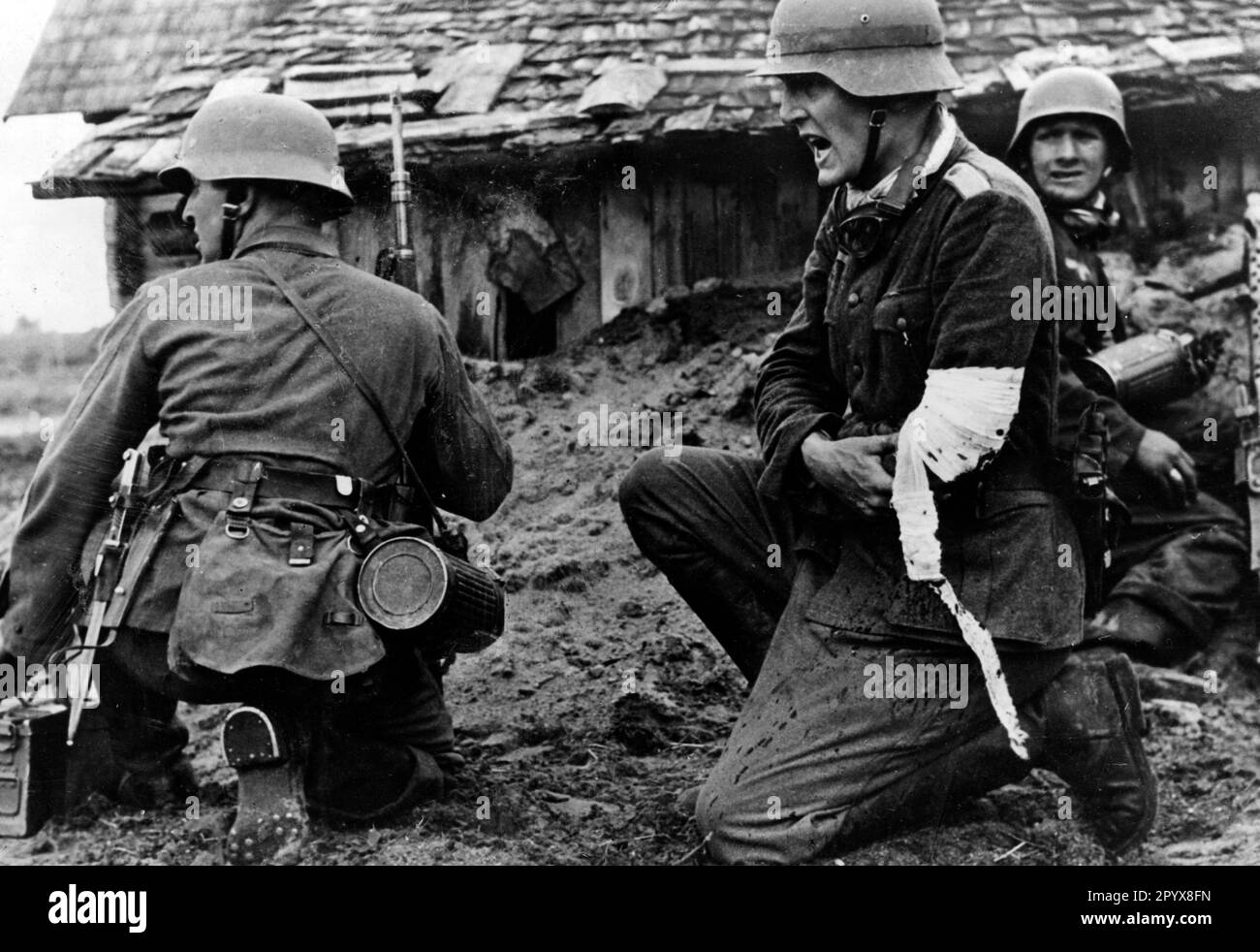 A wounded lieutenant gives orders during the battle for a village on the Eastern Front. Photo ...