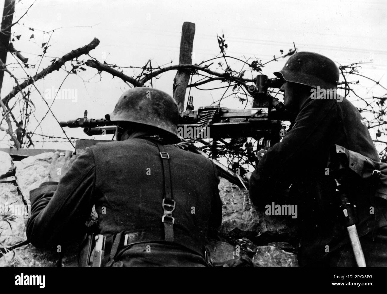 German soldiers with an MG 34 on a gun carriage during fighting on the ...