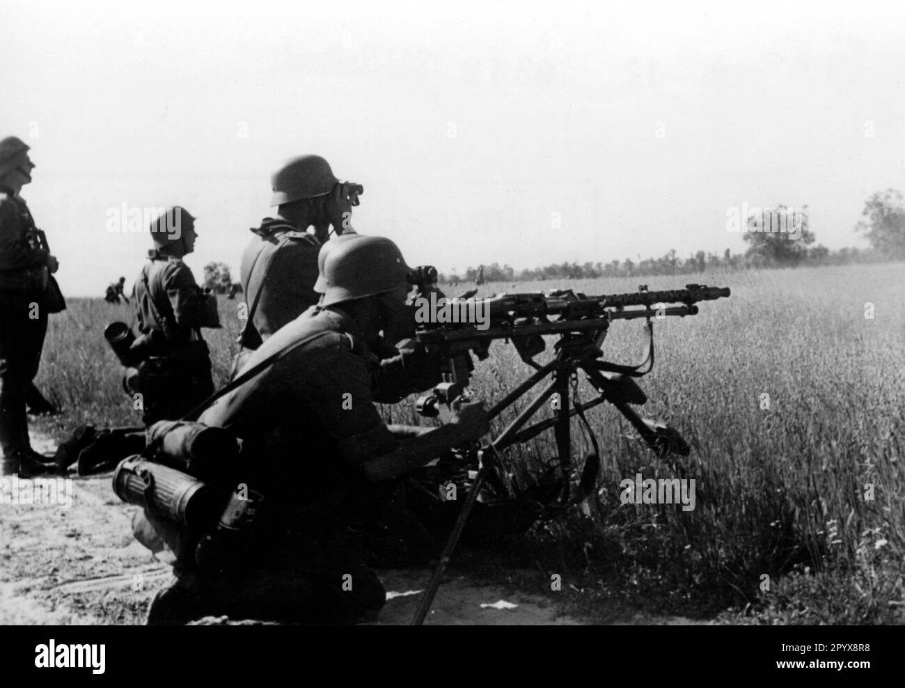 German soldiers with an MG 34 on a gun carriage during fighting on the ...