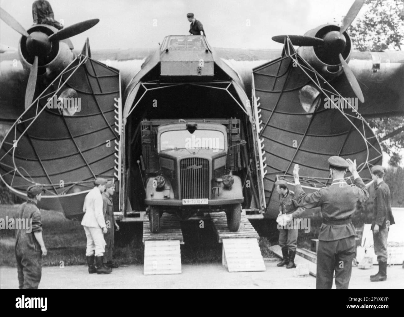 "An Opel Blitz truck is unloaded from a Messerschmitt Me 323 ""Gigant"" transport plane. Undated ...