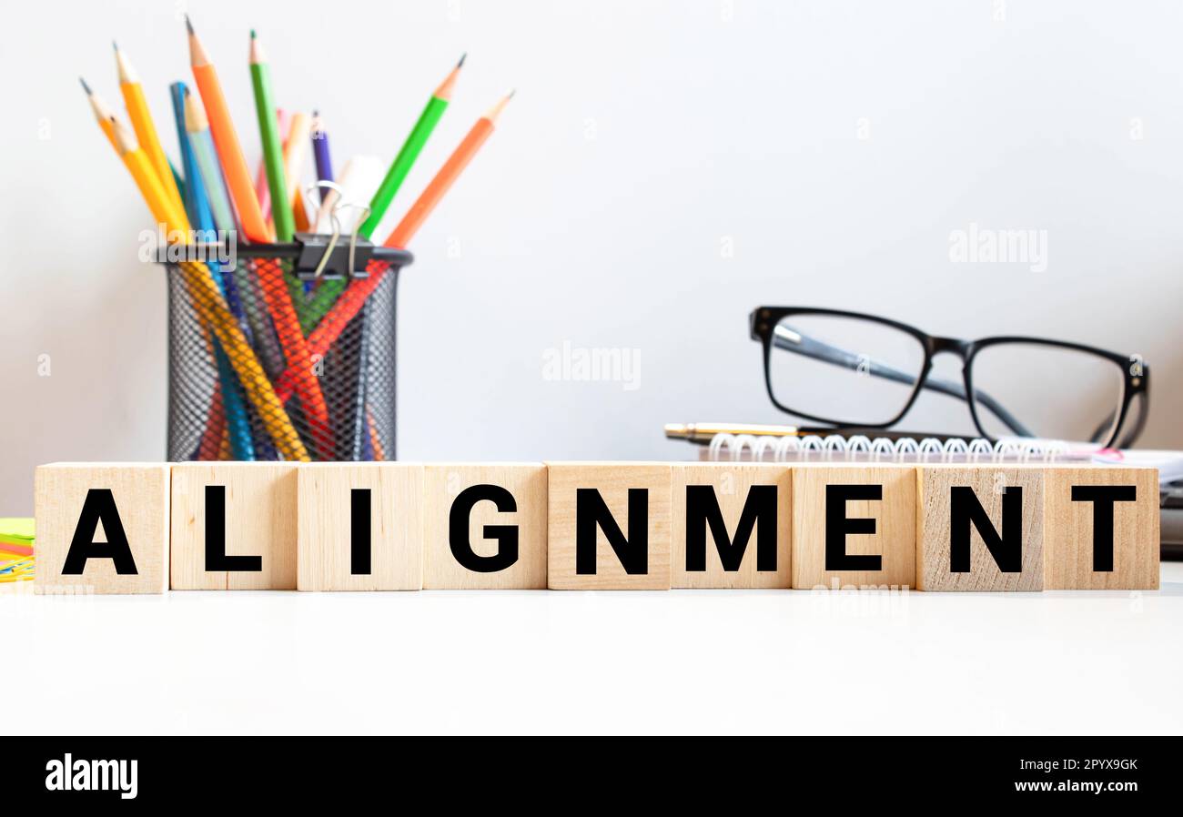 Alignment. Cubes form the word Alignment. Broad concept from business ...