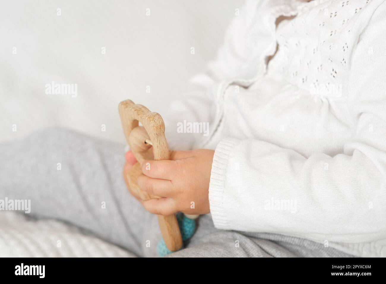 Cute baby girl playing tactile wooden and silicone toys. Young child ...