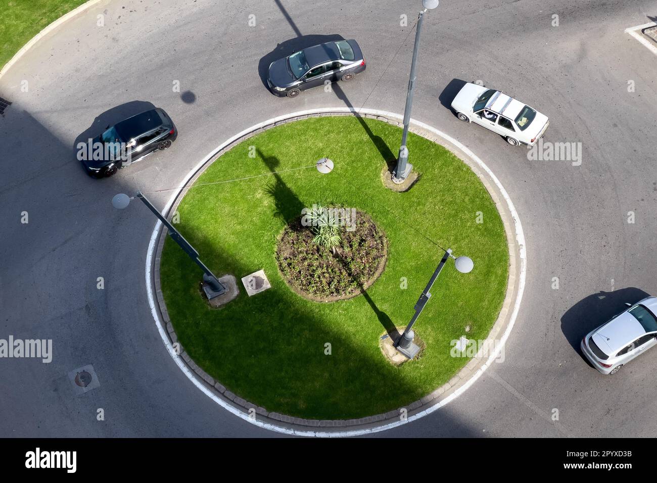 Cars drive around a roundabout Stock Photo - Alamy