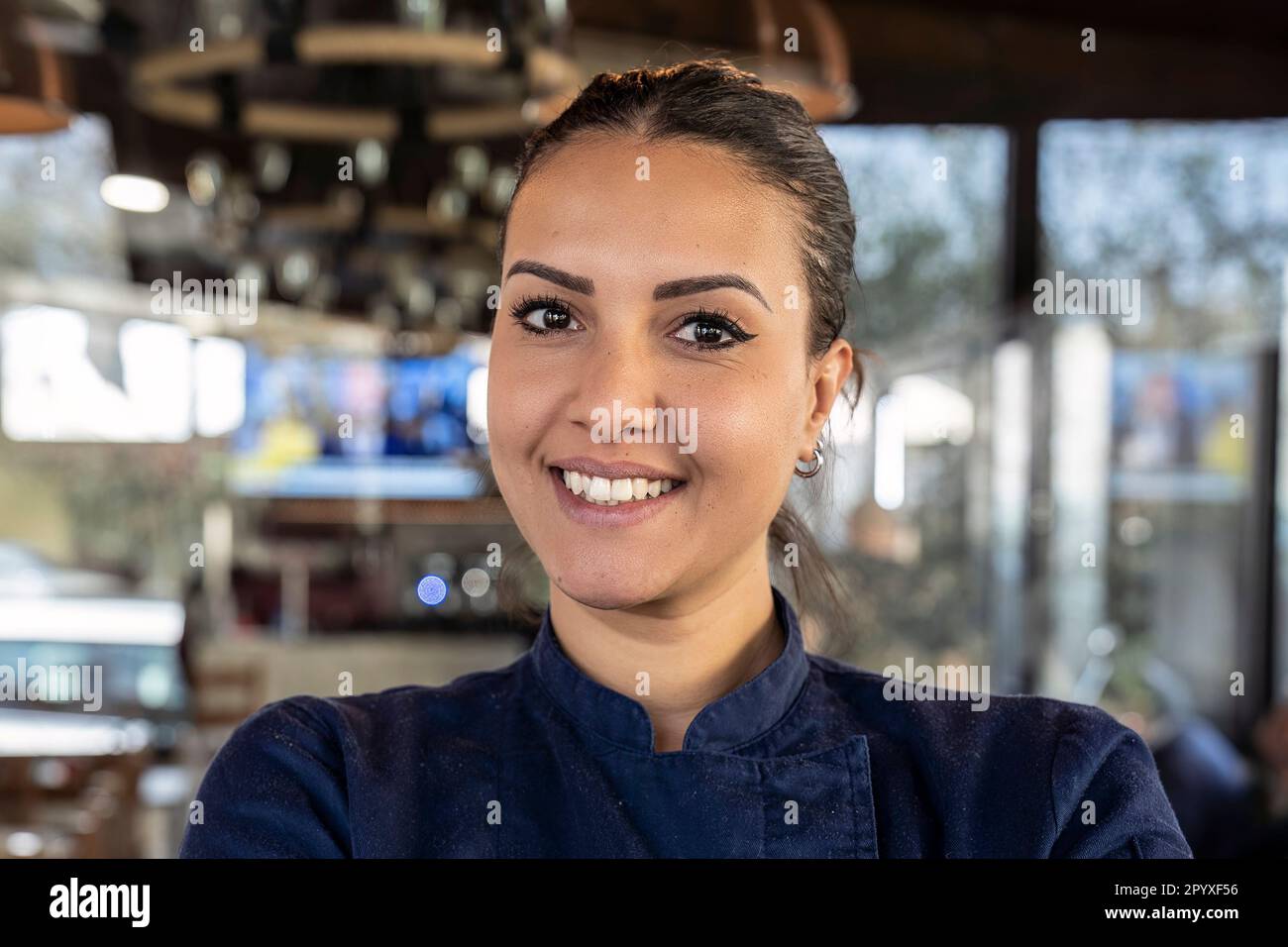 Young north african chef woman smiling on camera at the restaurant ...