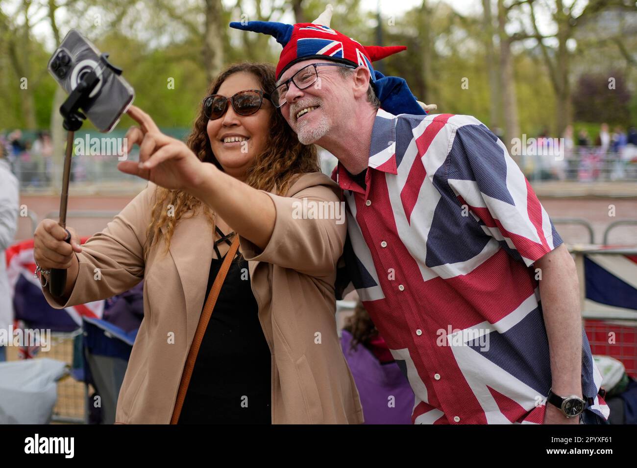 A woman takes selfie with a man wearing British colours at the Mall in ...