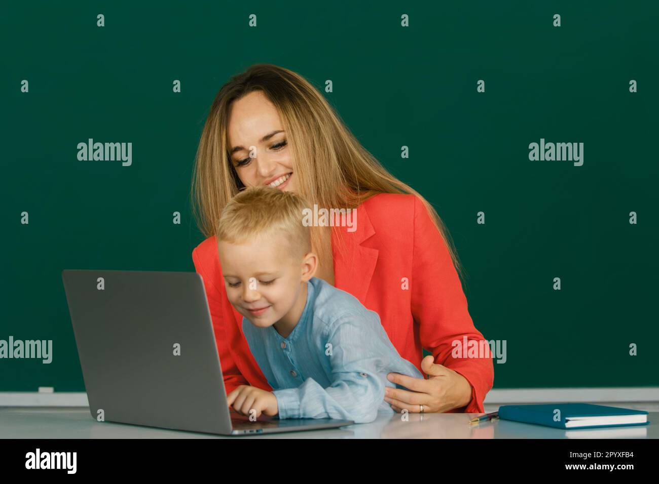Mother and son learning. Online school. Teacher helping school child ...