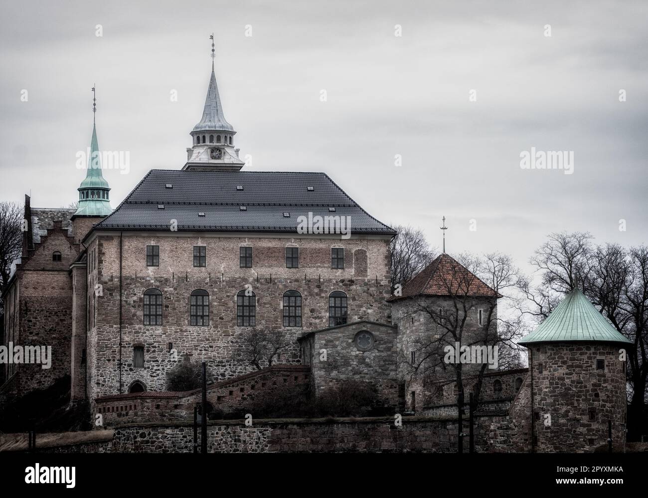 A traditional castle of red brick construction with a tall tower ...