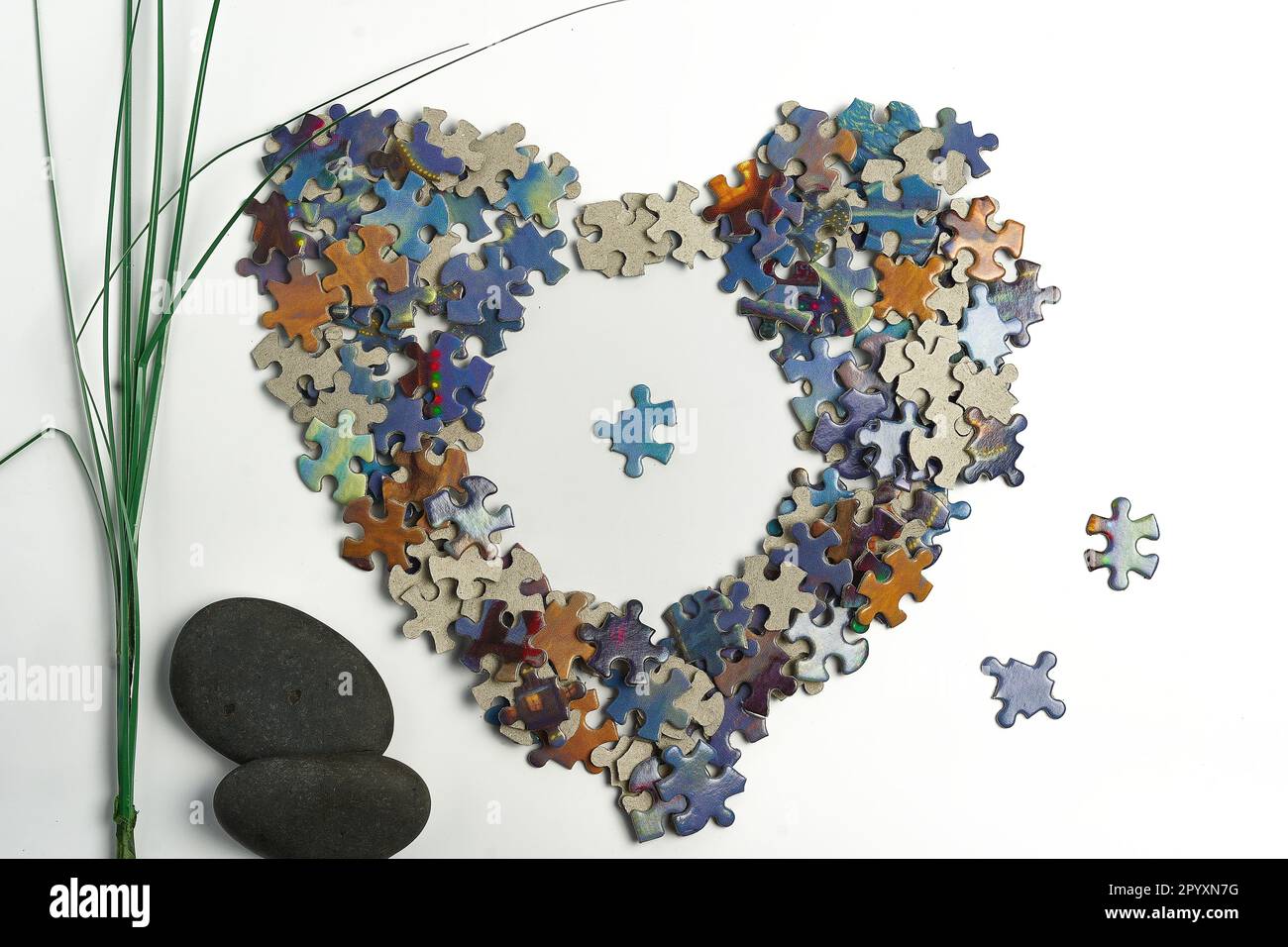 Smooth rocks and puzzle pieces shaped in the form of a heart - the ...