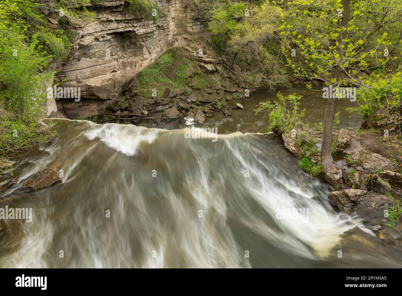 A waterfall running over a cliff seen from above Stock Photo - Alamy