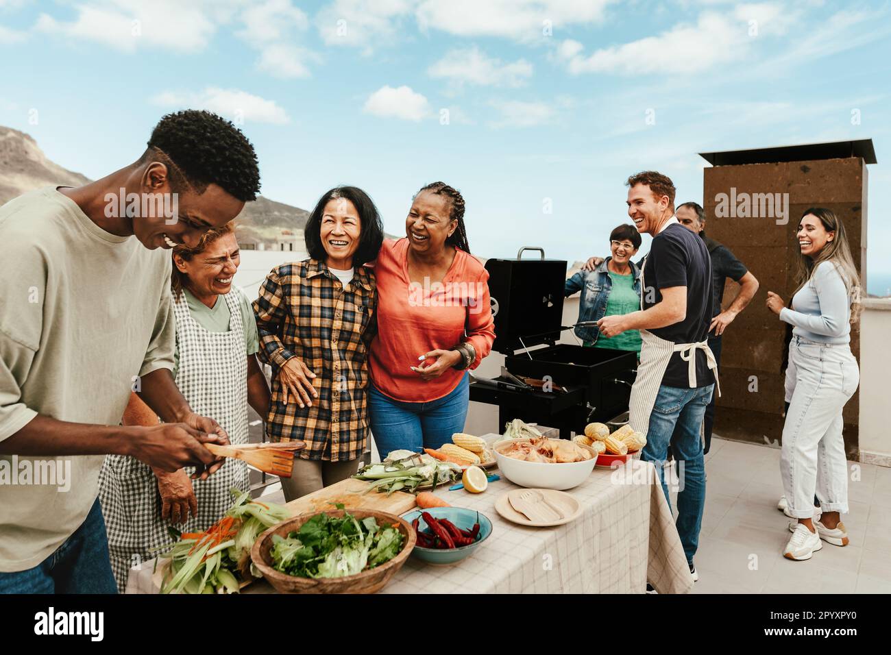 Happy multigenerational people having fun doing barbecue grill at house ...