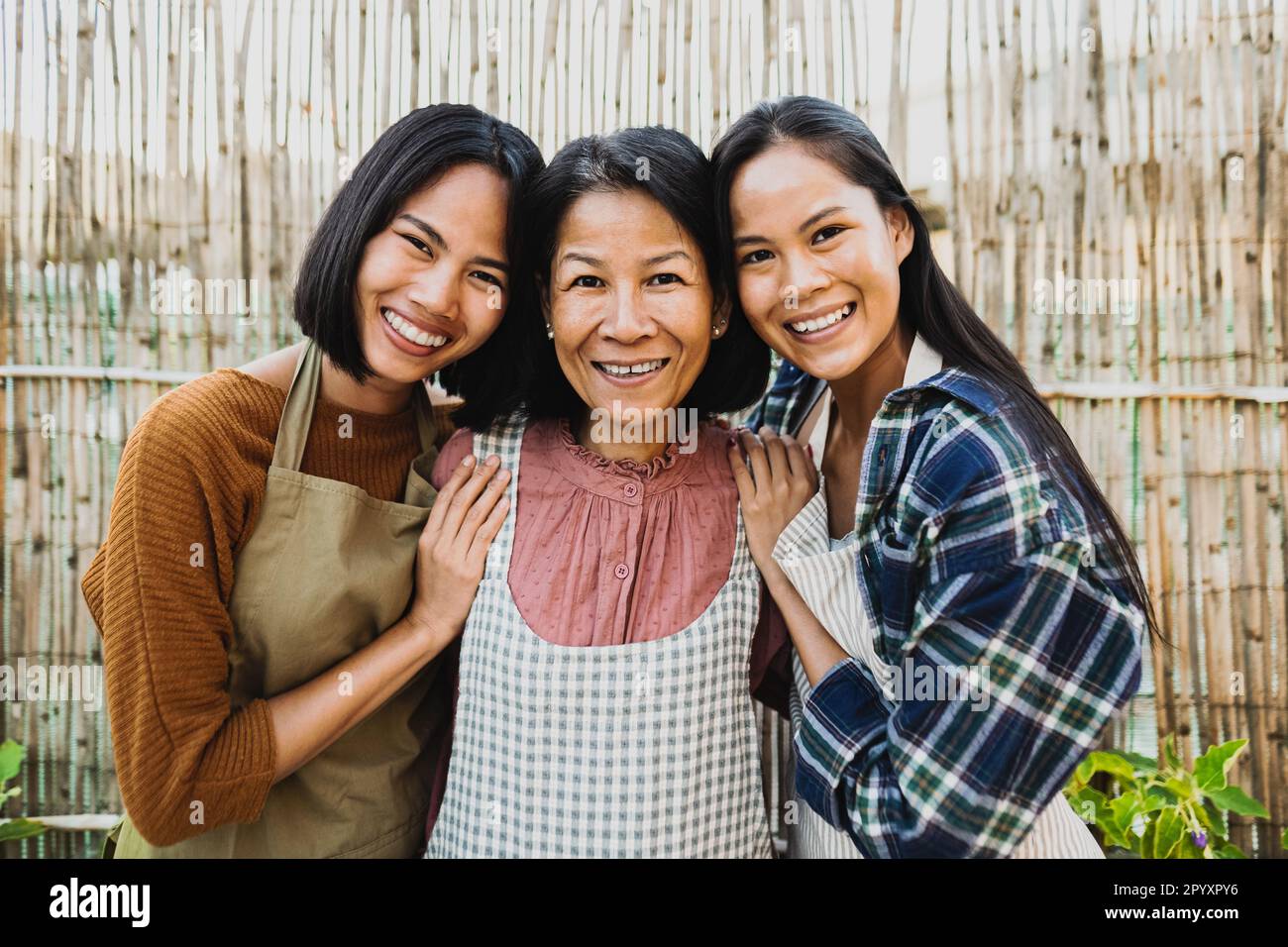 Happy Thai family having fun smiling in front of camera while preparing ...