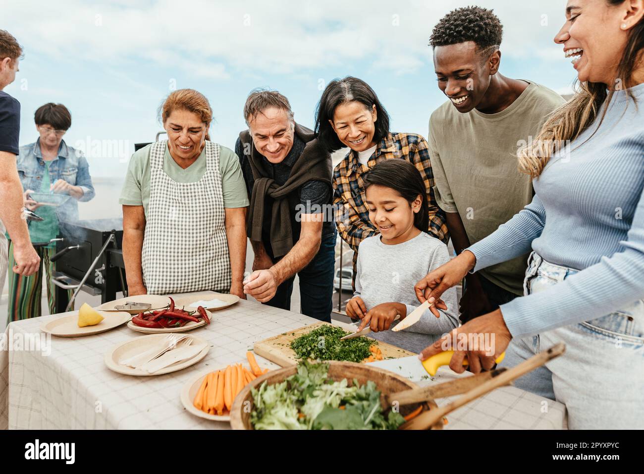 Multi generational people having fun doing barbecue at house rooftop ...